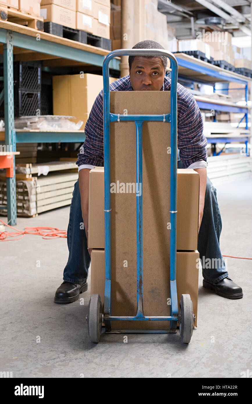 Man with sack barrow Stock Photo - Alamy