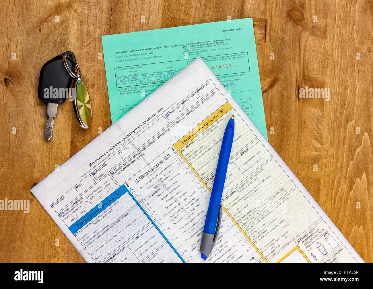 On a wooden surface lie the international motor insurance documents ...