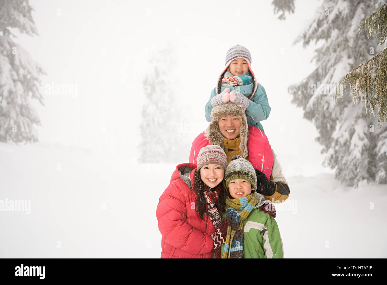 Family in the snow Stock Photo - Alamy