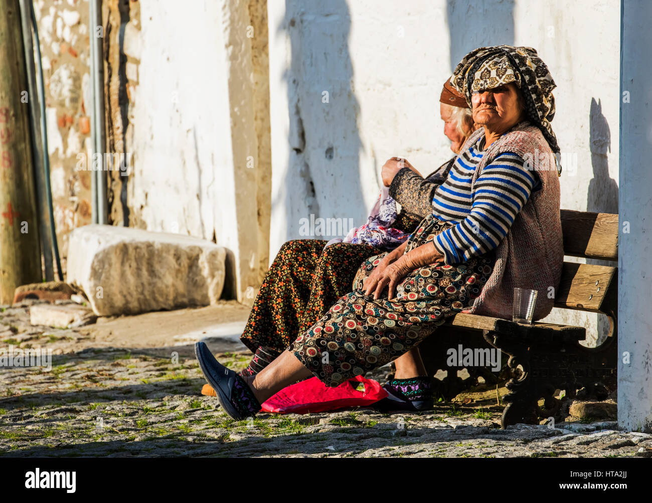 Elderly Turkish women sitting together on a bench; Selcuk, Izmir ...