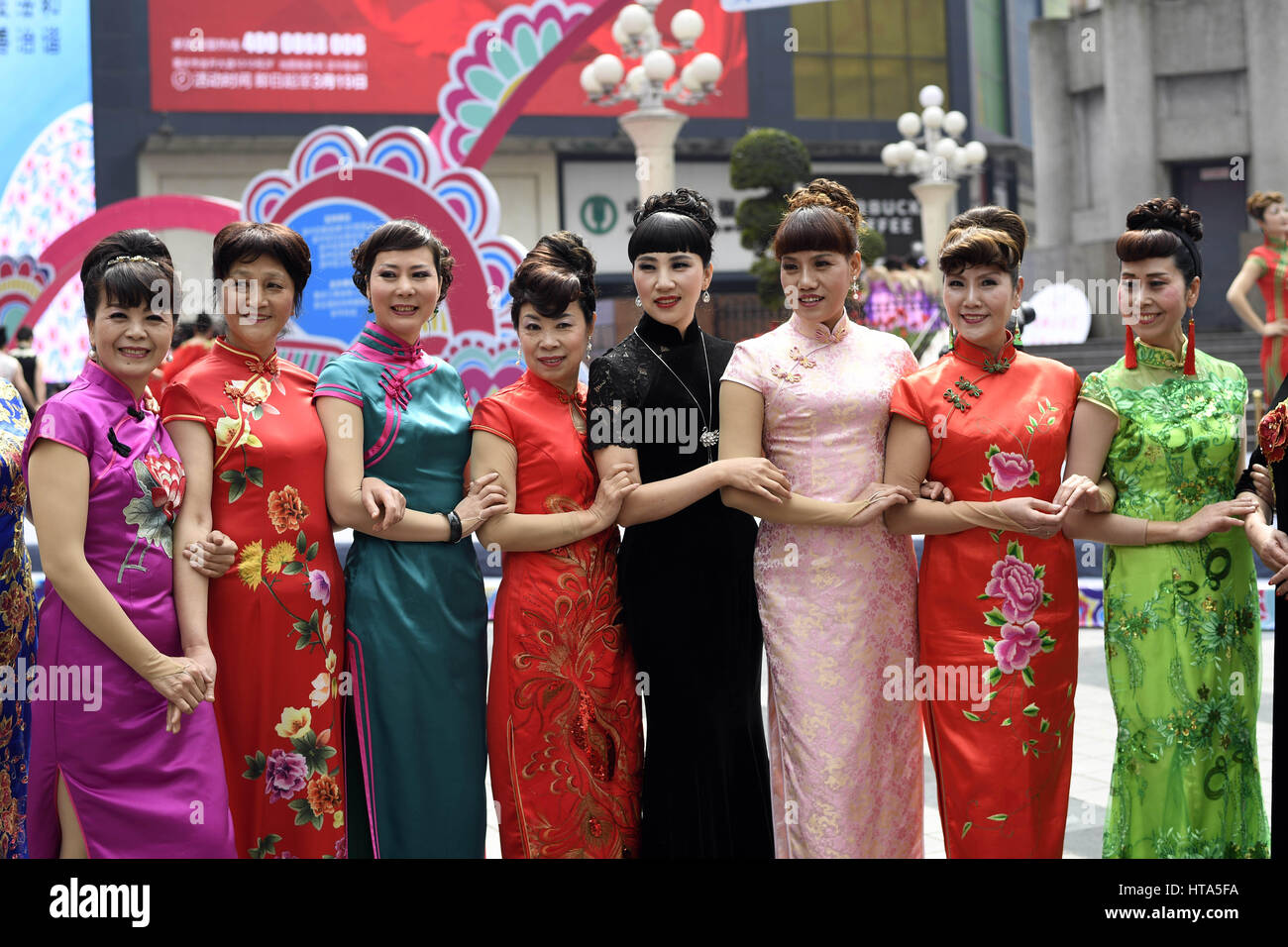 Chongqing, China. 8th Mar, 2017. More than 500 women present cheongsam ...