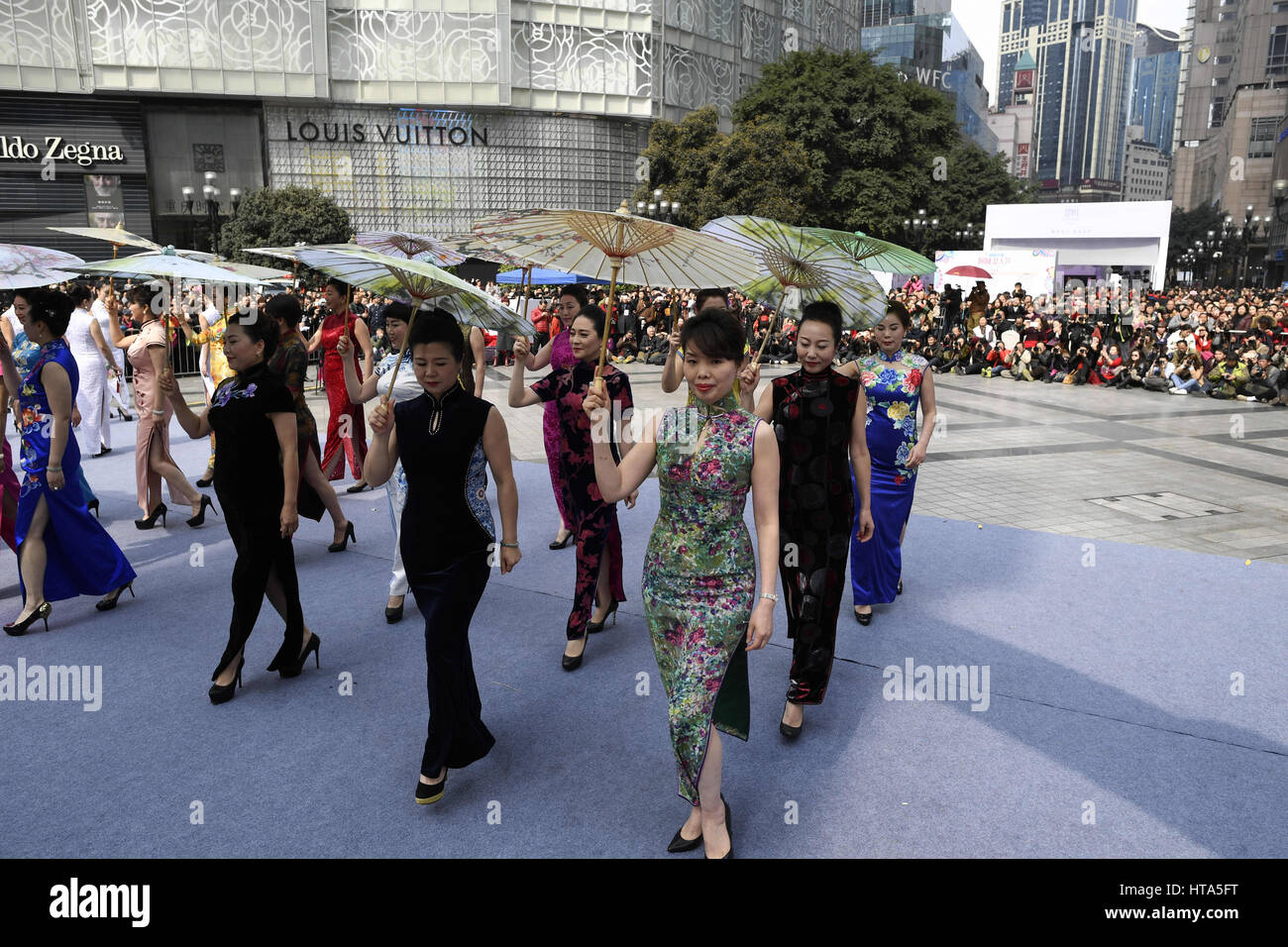 Chongqing, China. 8th Mar, 2017. More than 500 women present cheongsam ...