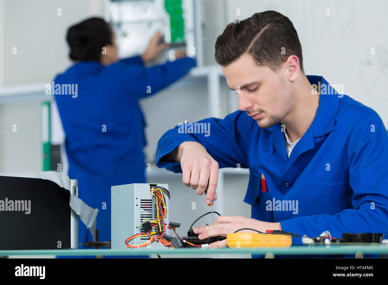 team of students examining and repairing computer parts Stock Photo - Alamy