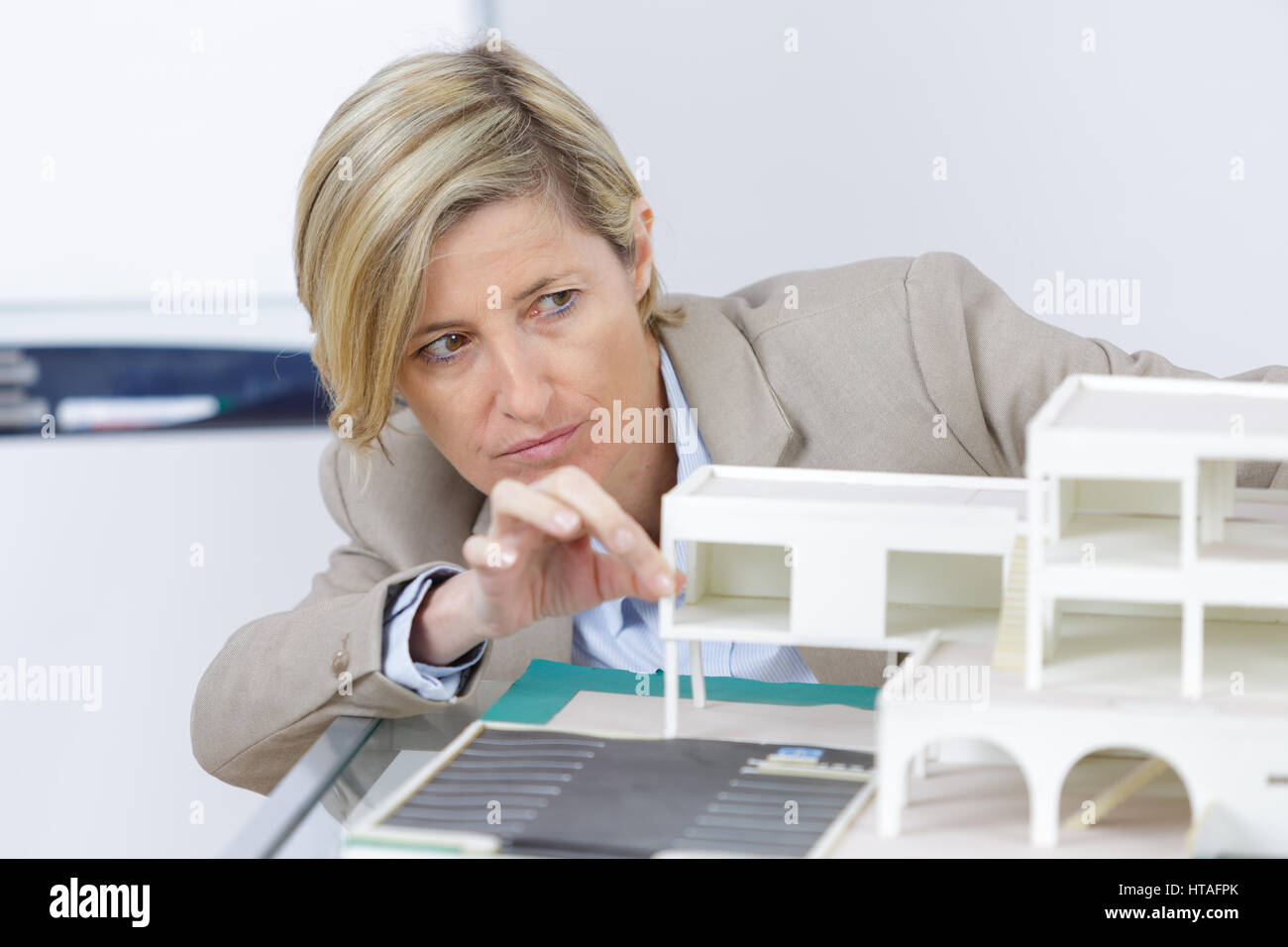 realtor woman reviewing scale model of houses Stock Photo - Alamy