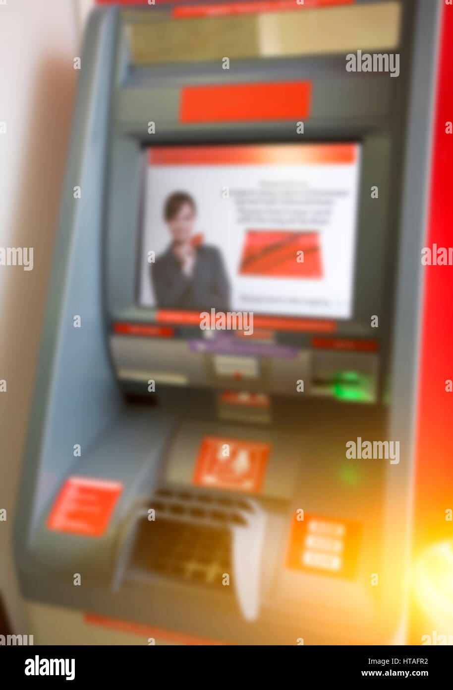 Red cash dispenser inside room Stock Photo - Alamy