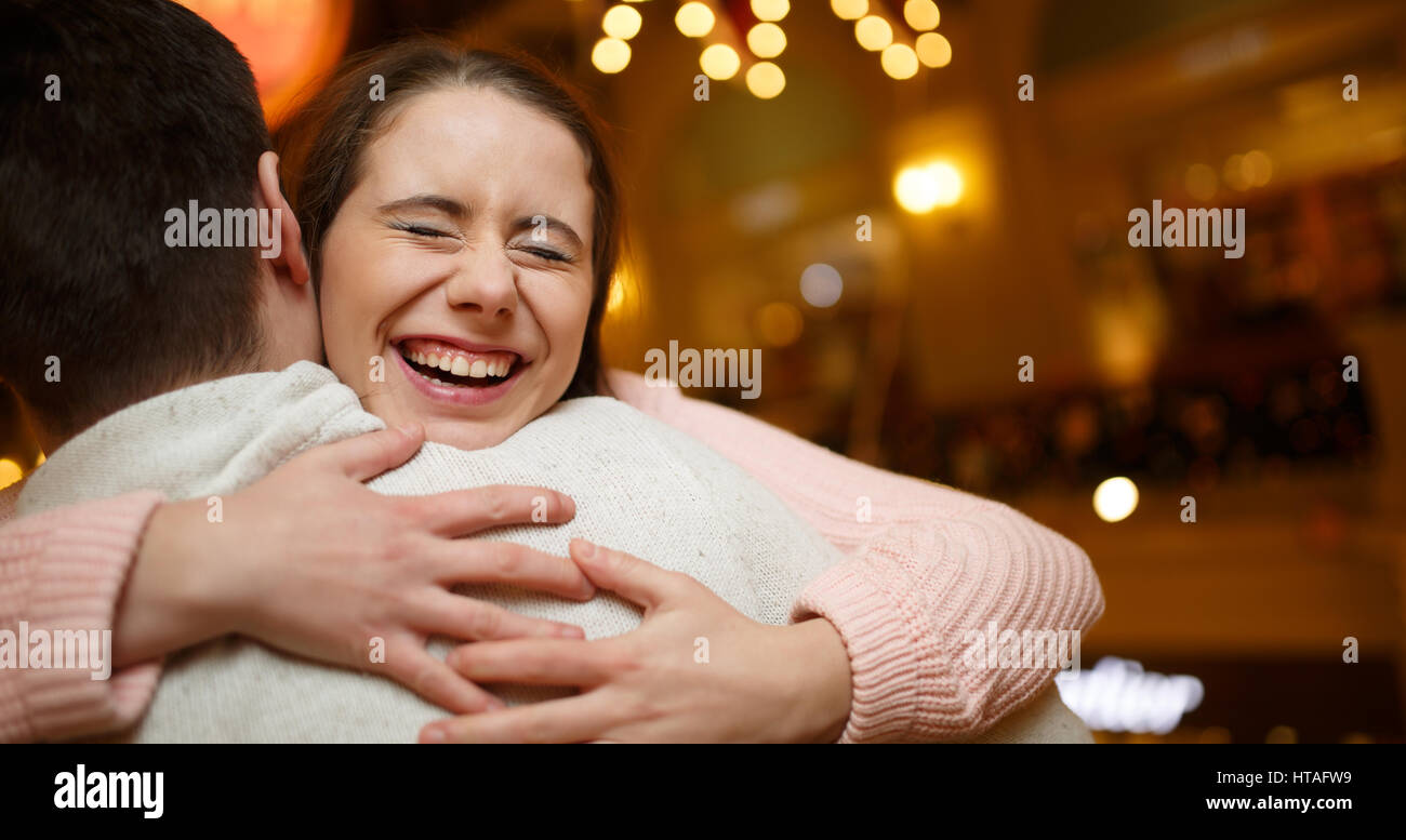 Couple hugging in shopping mall Stock Photo - Alamy