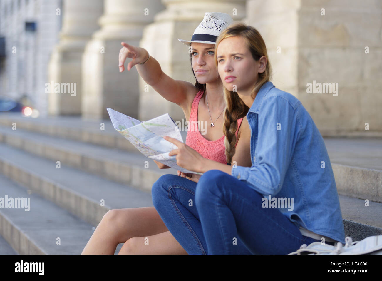 lost and confused girl friends looking for directions on map Stock ...
