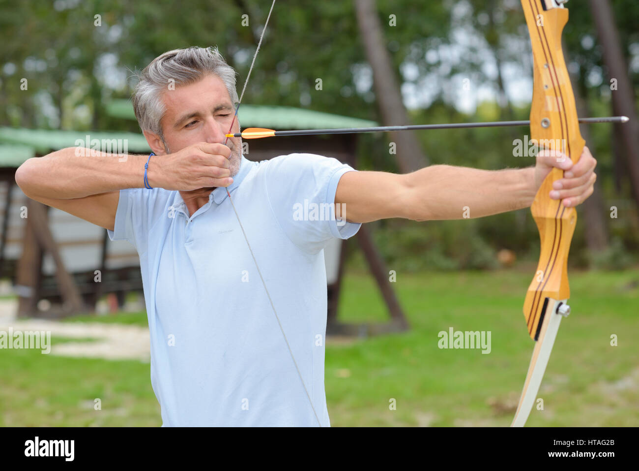 pulling the arrow string Stock Photo - Alamy