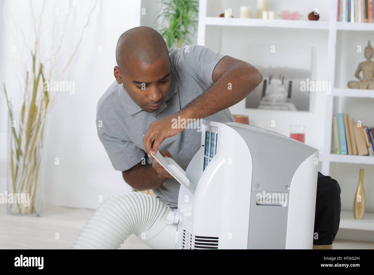 Man working on residential air conditioner Stock Photo - Alamy