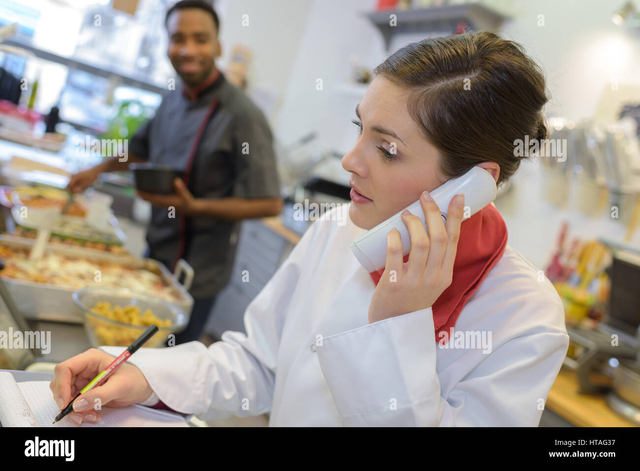 Young saleswoman behind counter hi-res stock photography and images - Alamy