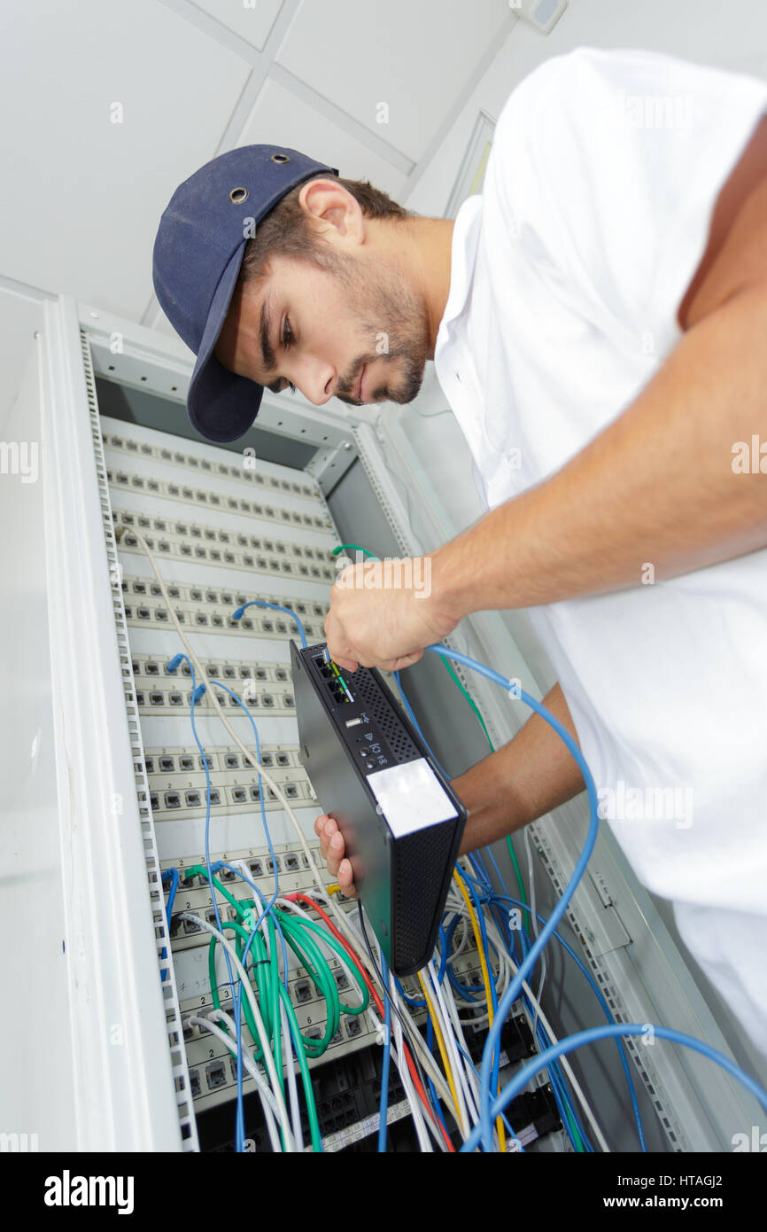 Electrician carefully installing electrical hi-res stock photography ...