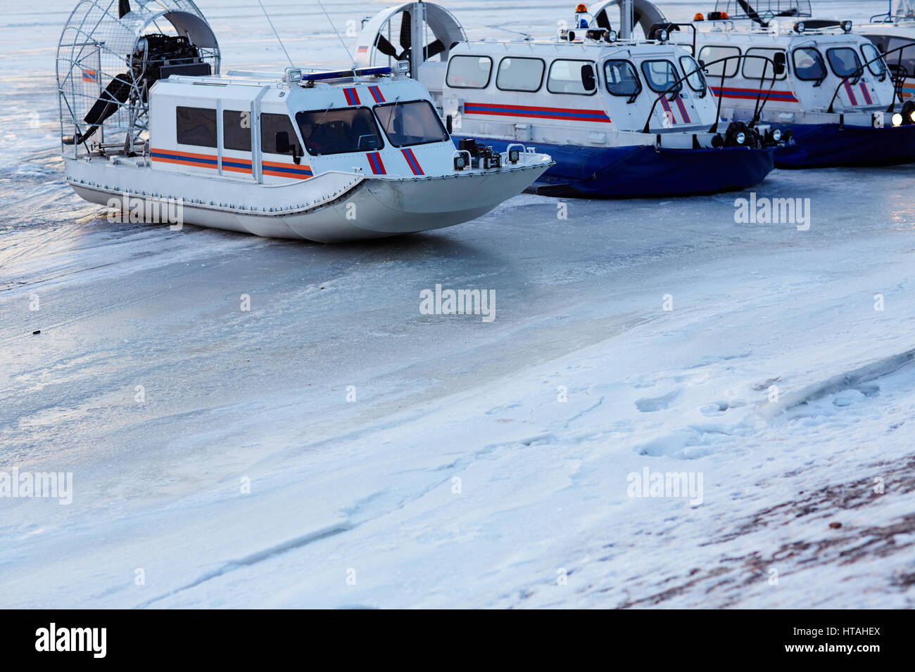 Row of coast guard boats on river bank Stock Photo - Alamy