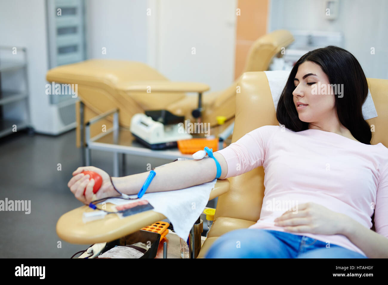 Young woman giving her blood in hemotransfusion center Stock Photo - Alamy