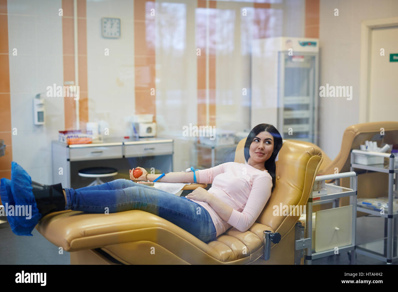 Young female sitting in hemotransfusion center Stock Photo - Alamy