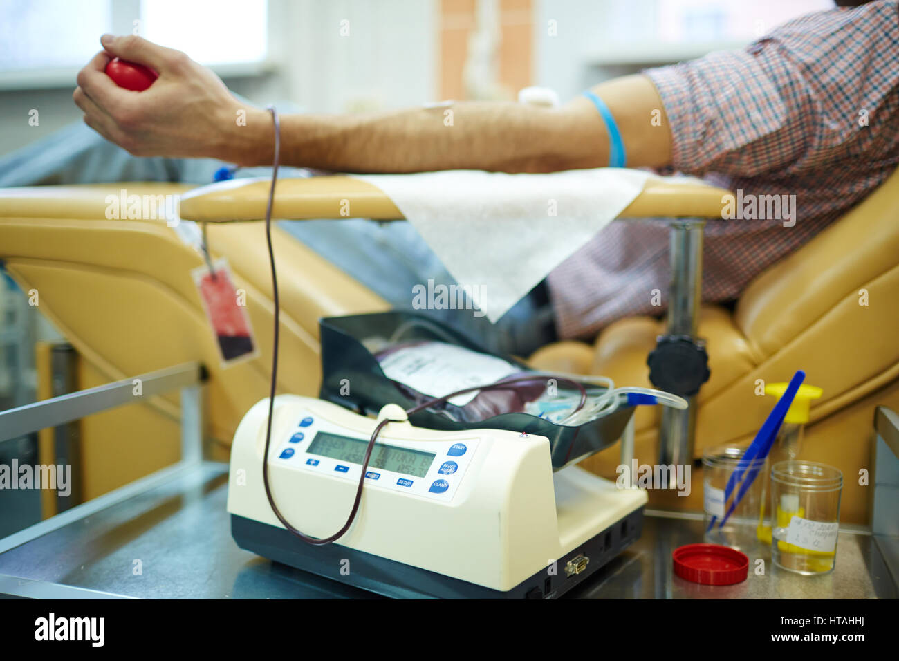 Equipment for donating blood and human lying in armchair on background ...
