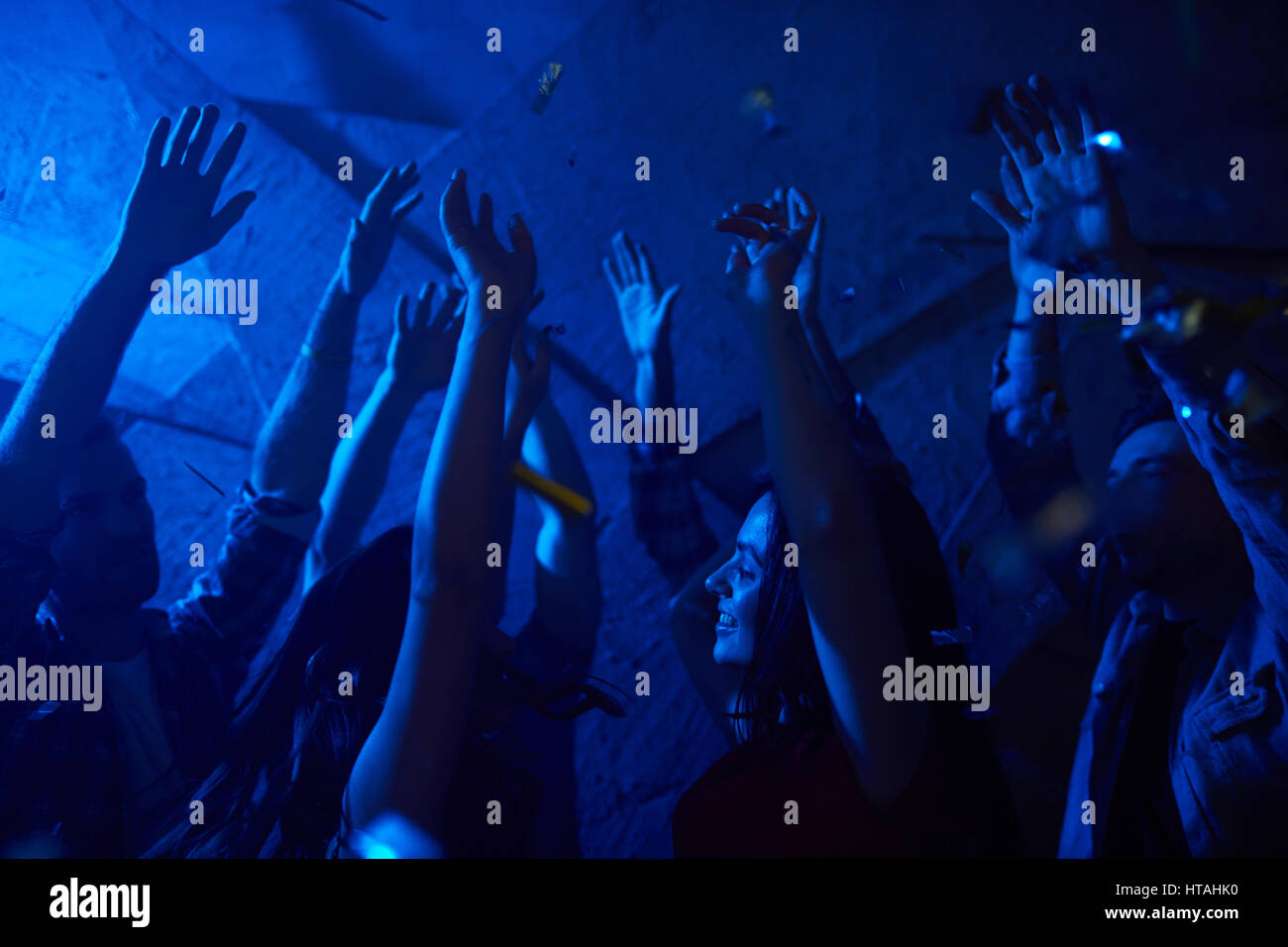 Friends dancing with raised hands in club Stock Photo - Alamy