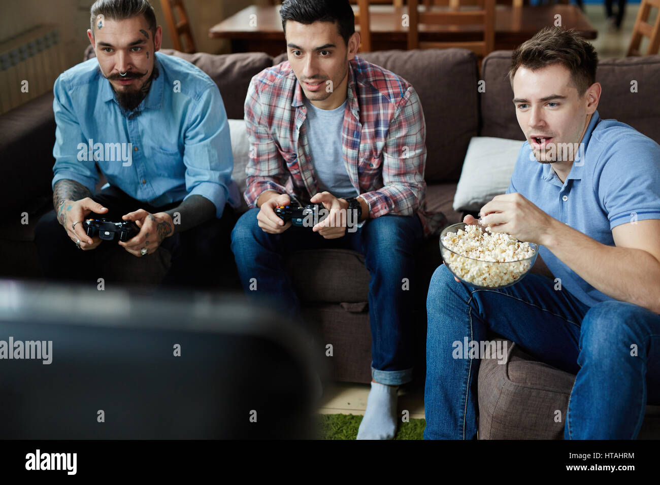 Restful guys playing and watching video games Stock Photo - Alamy