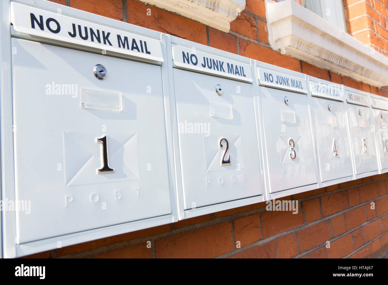 Line Of Mailboxes With No Junk Mail Notice Stock Photo - Alamy