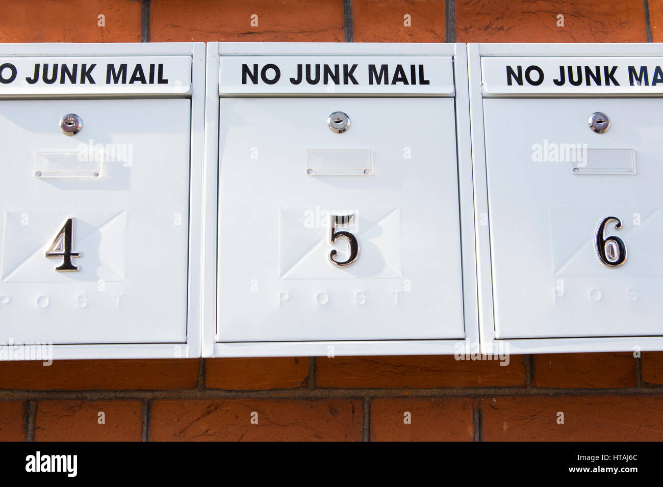 Line Of Mailboxes With No Junk Mail Notice Stock Photo - Alamy