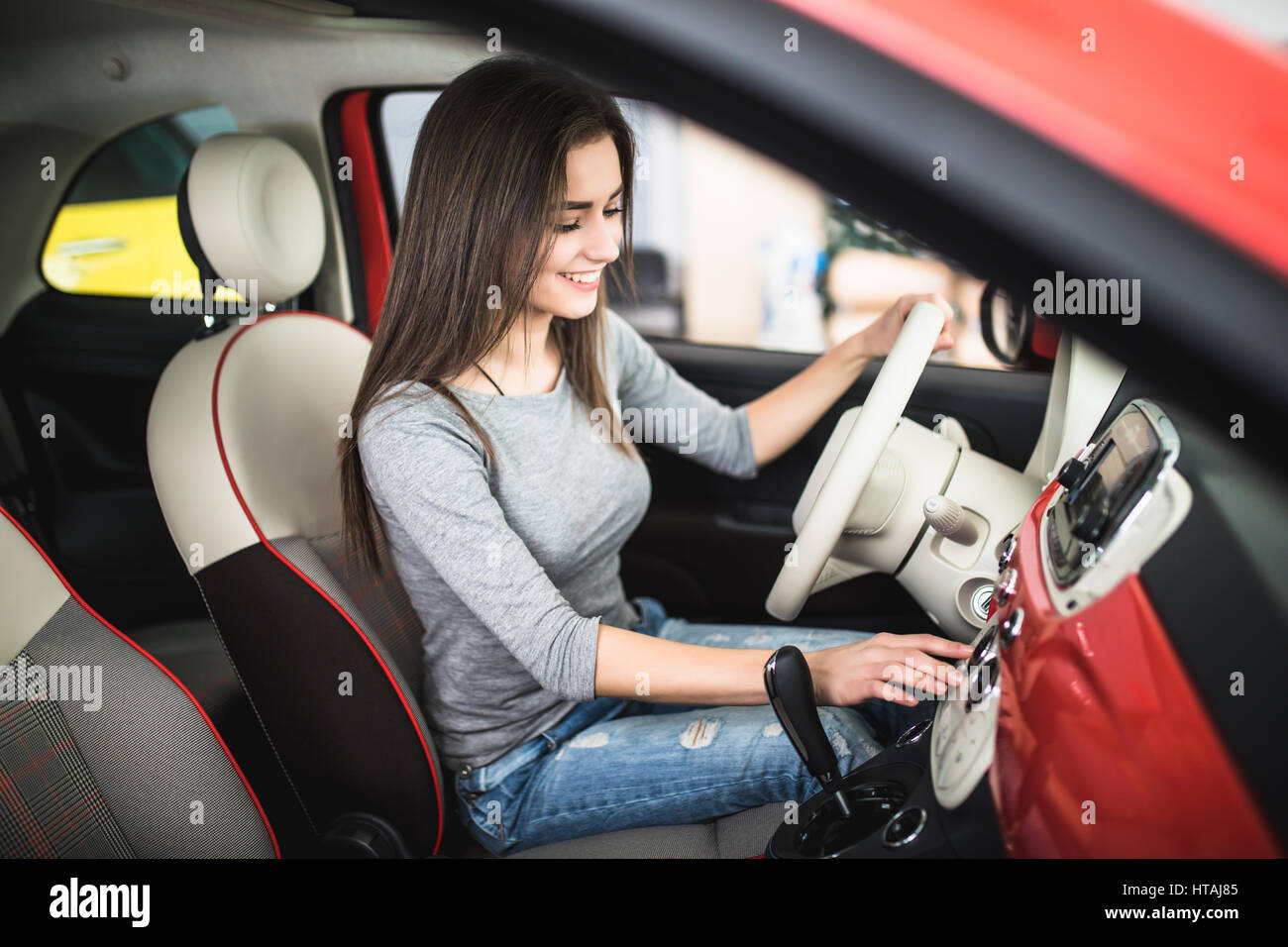 Woman driving new and modern car and use dashboard panel in car Stock ...