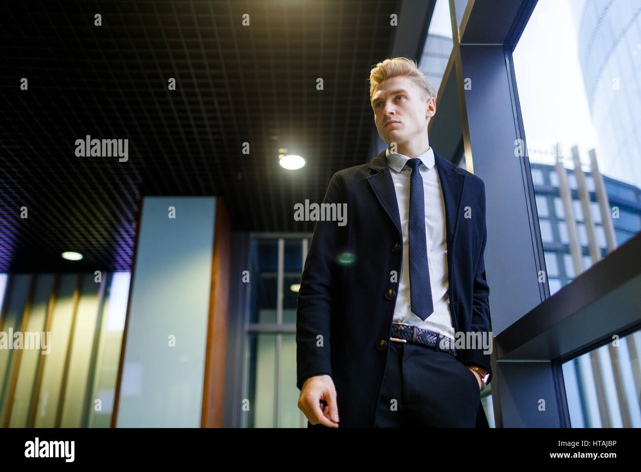 Classy businessman in formal suit standing by window Stock Photo - Alamy