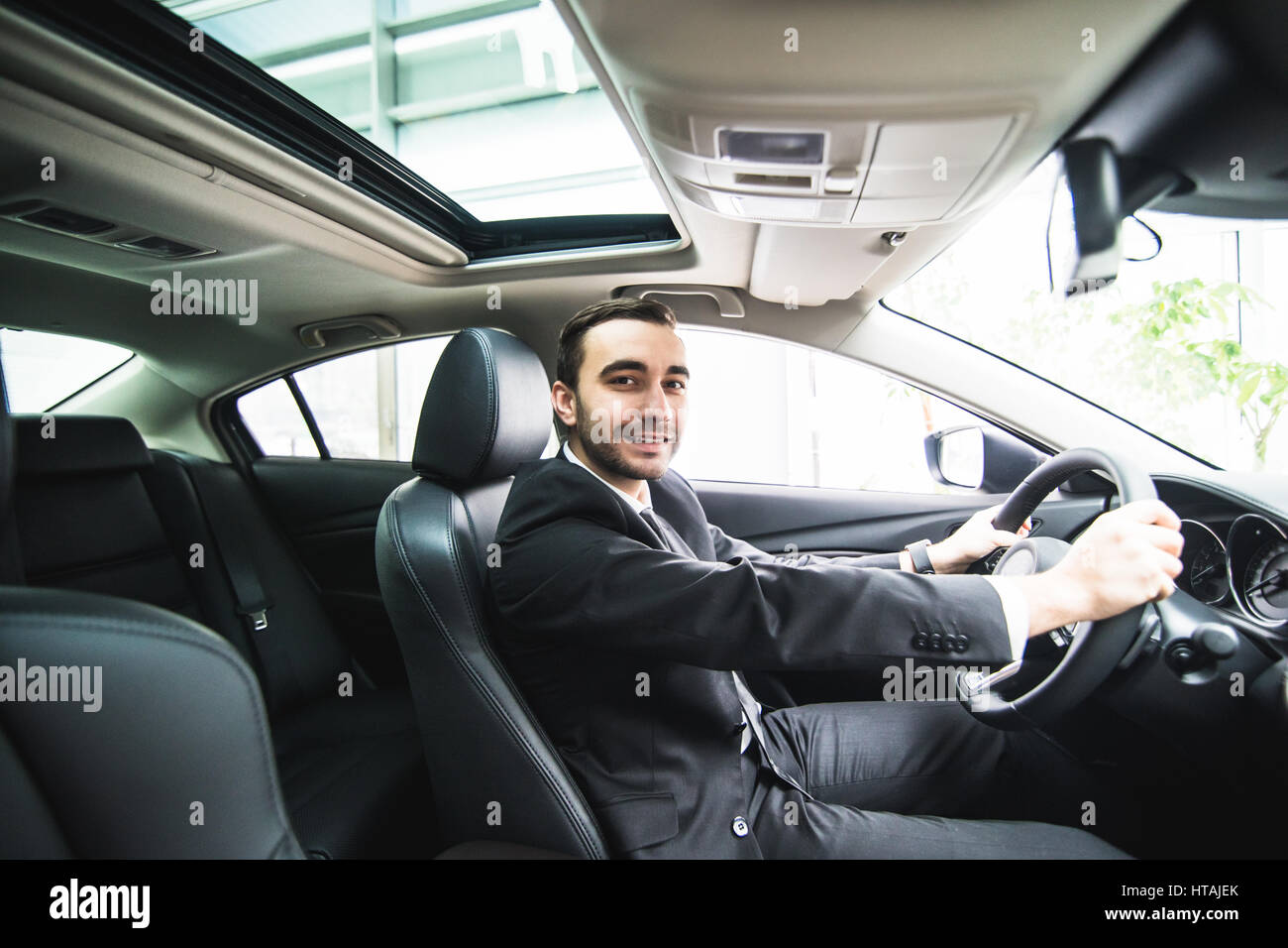 Man driving car and look at pasanger place inside car Stock Photo - Alamy