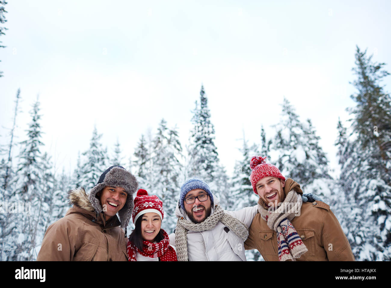 Group of youthful friends in winter forest Stock Photo - Alamy