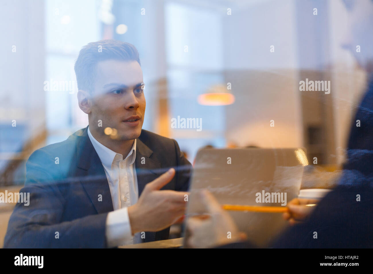 Young man answering questions at interview Stock Photo - Alamy