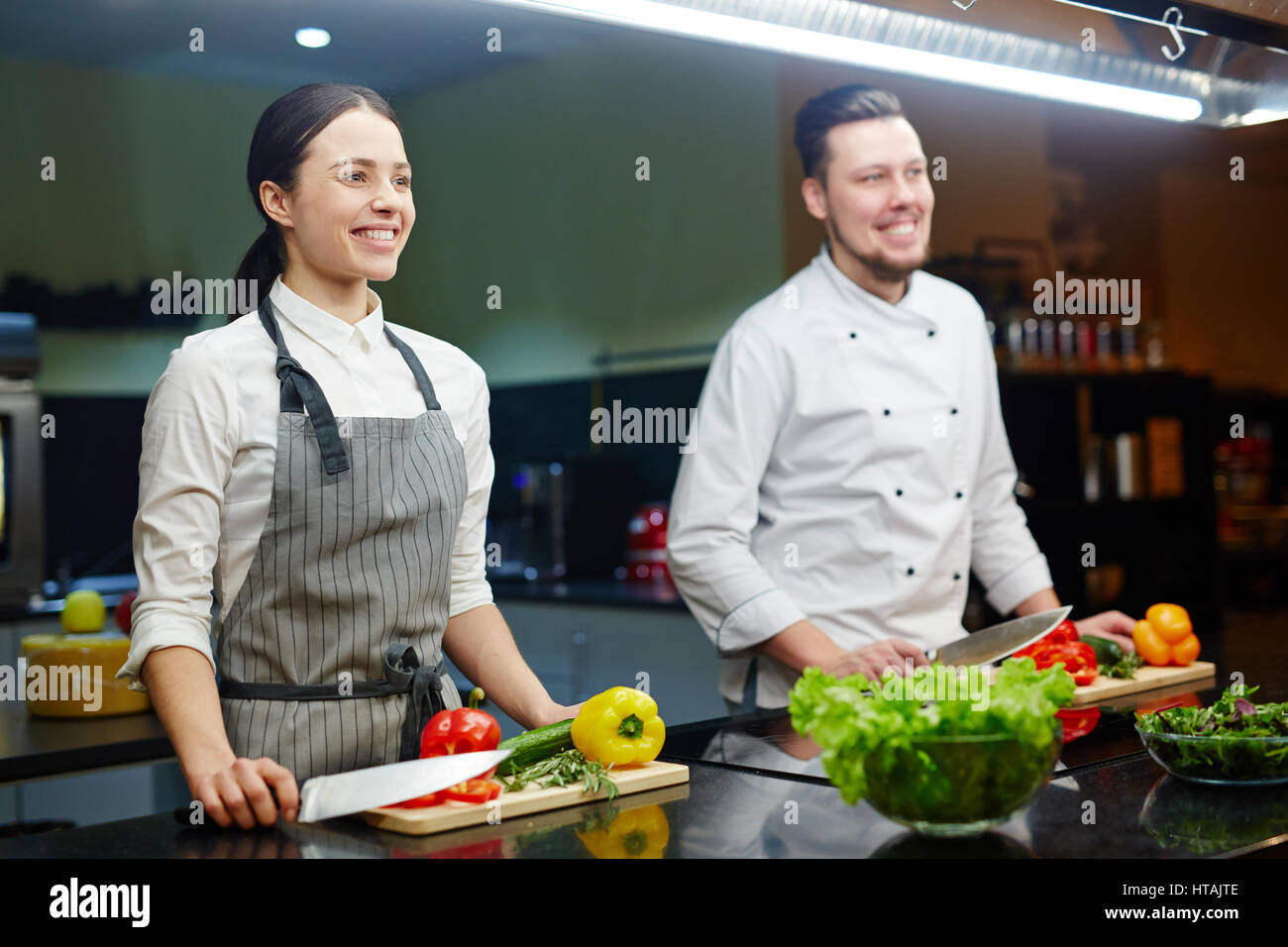 Happy group of kitchen workers or trainees ready to cook fresh ...