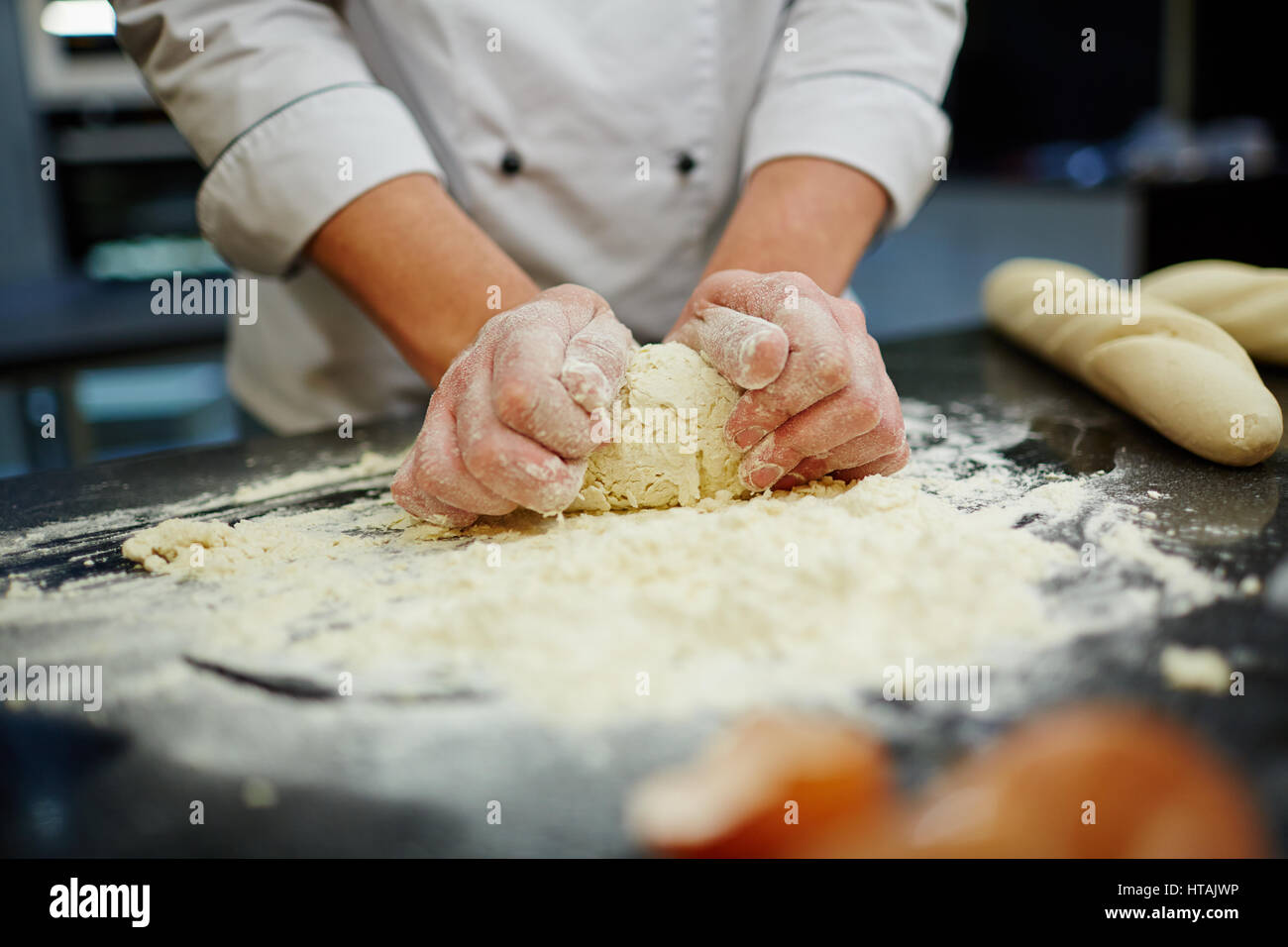 Professional baker kneading dough for bread or pastry Stock Photo - Alamy