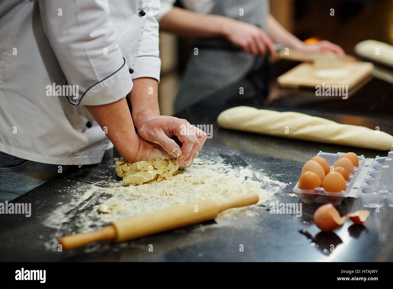 Hands of baker kneading dough in flour Stock Photo - Alamy