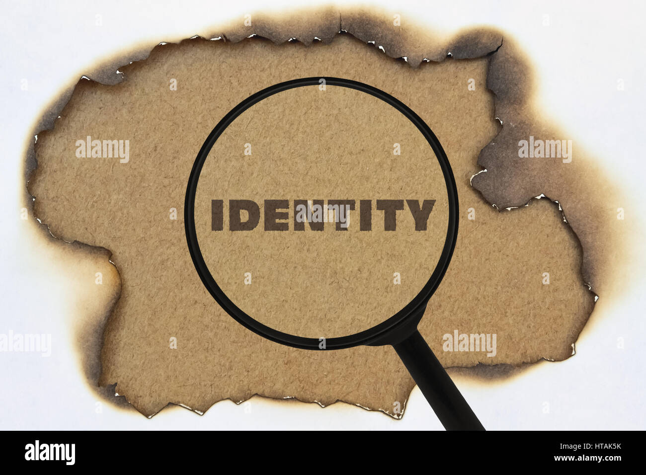 Word Identity under a magnifier on burnt yellow paper Stock Photo - Alamy