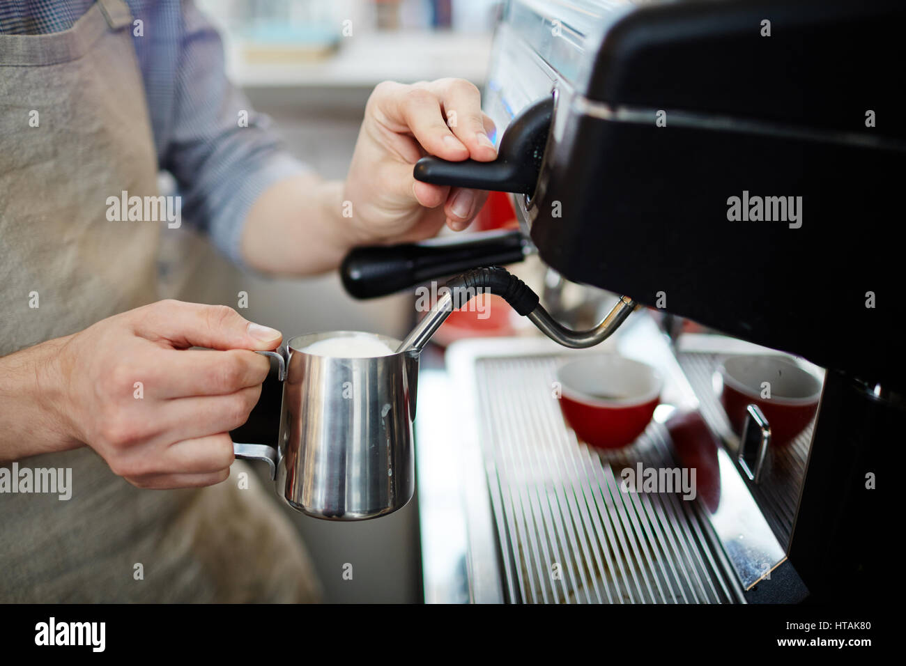Barista steaming fresh milk for coffee Stock Photo - Alamy