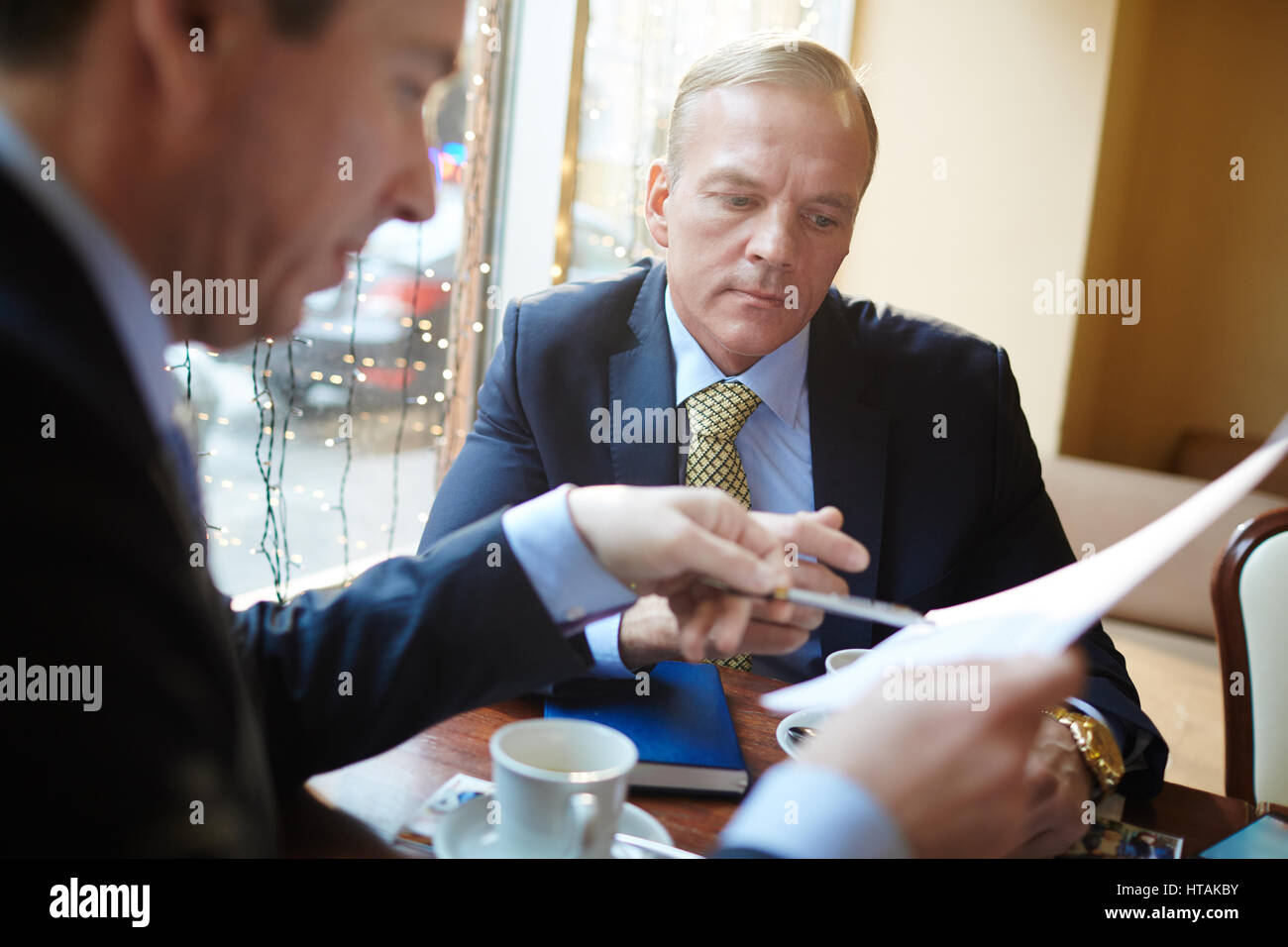 Small group of bankers discussing financial document at meeting Stock ...
