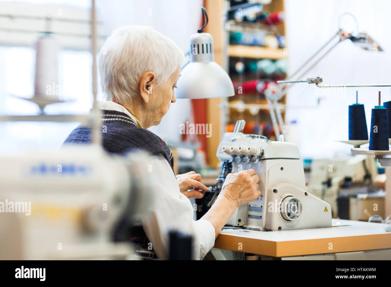 Mature woman working sewing machine hi-res stock photography and images ...