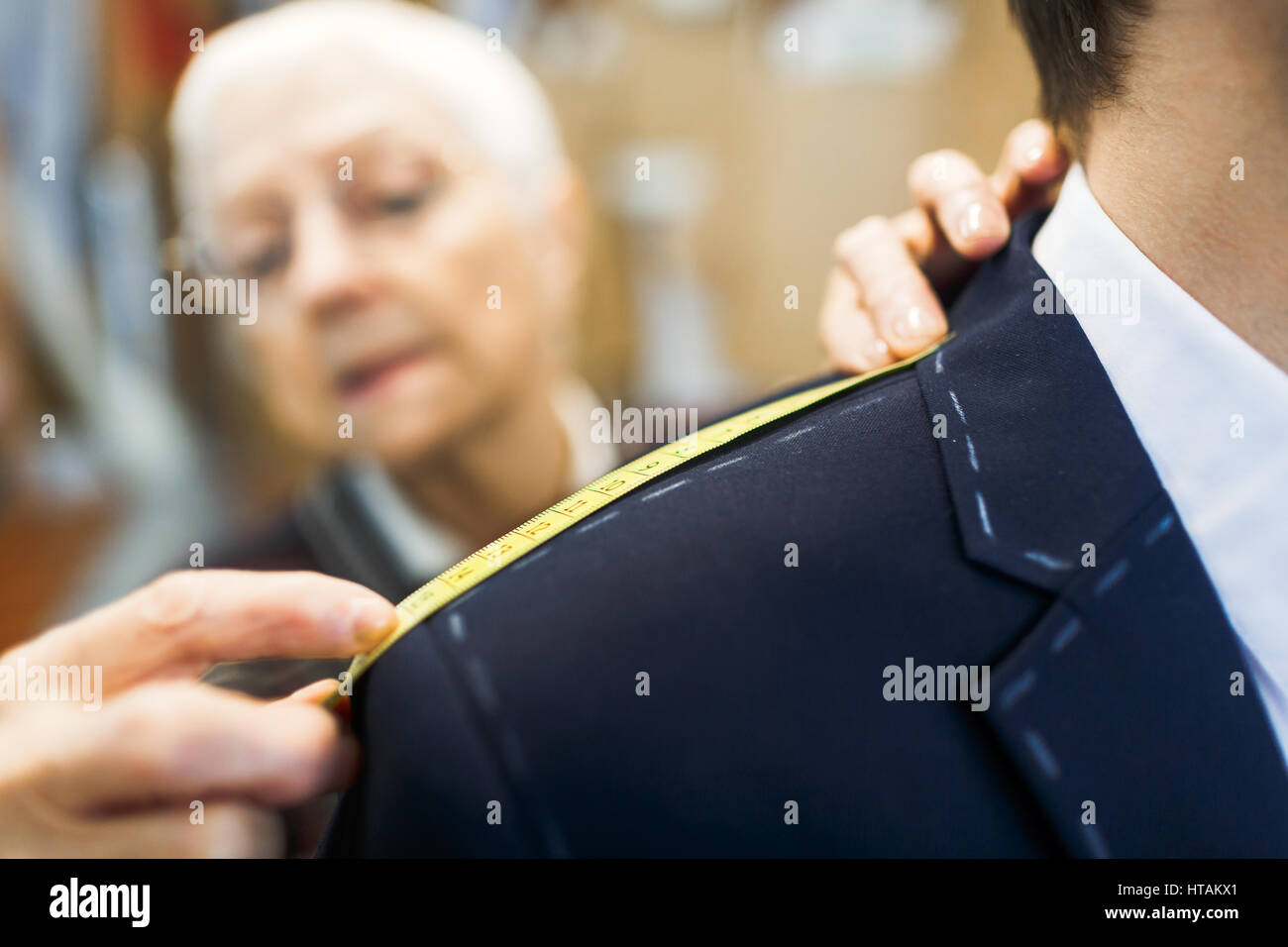 Tailor measuring jacket length hi-res stock photography and images - Alamy
