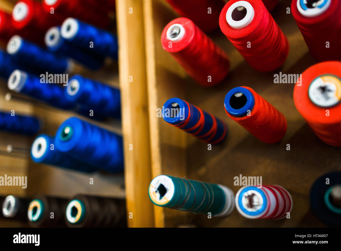 Collection of threads on spools in tailoring-shop Stock Photo - Alamy