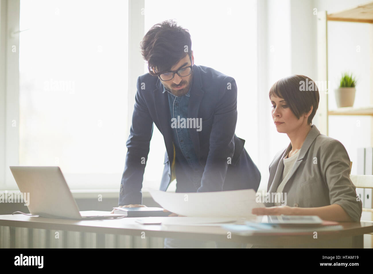 Portrait of modern male supervisor giving instructions to employee ...