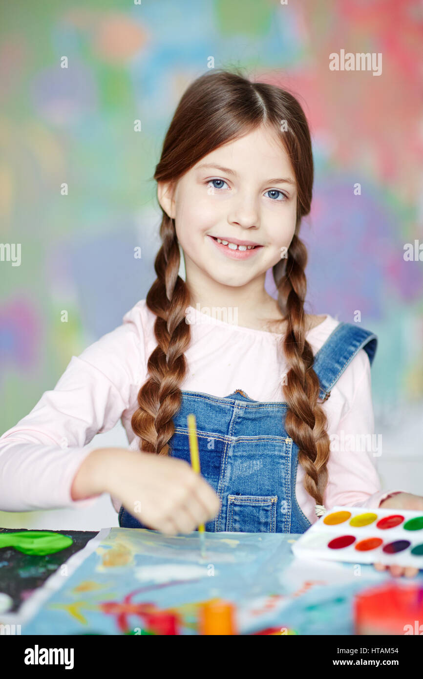 Inspired girl painting with watercolors Stock Photo - Alamy