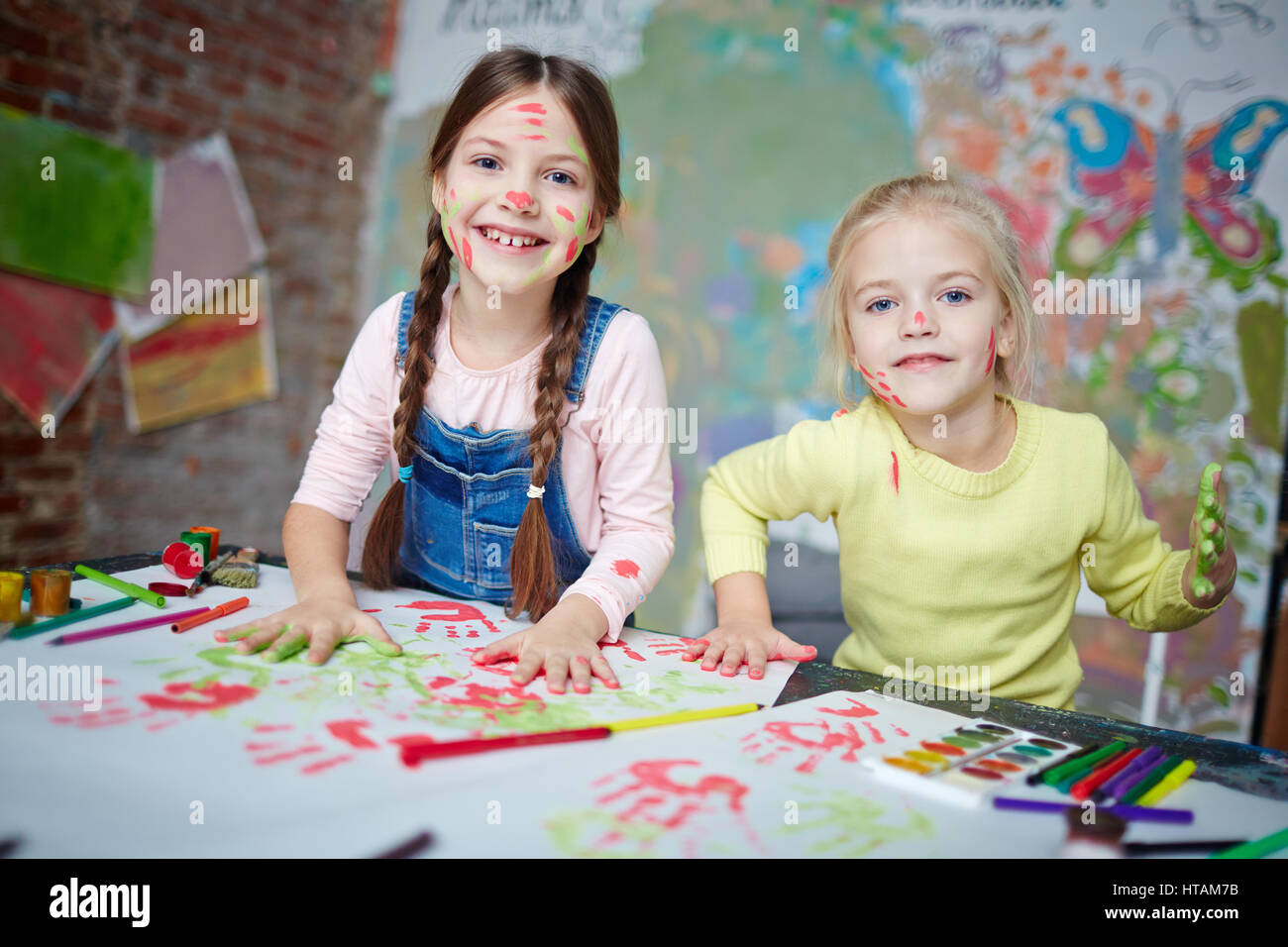 Creative girls making their hand-prints on paper Stock Photo - Alamy