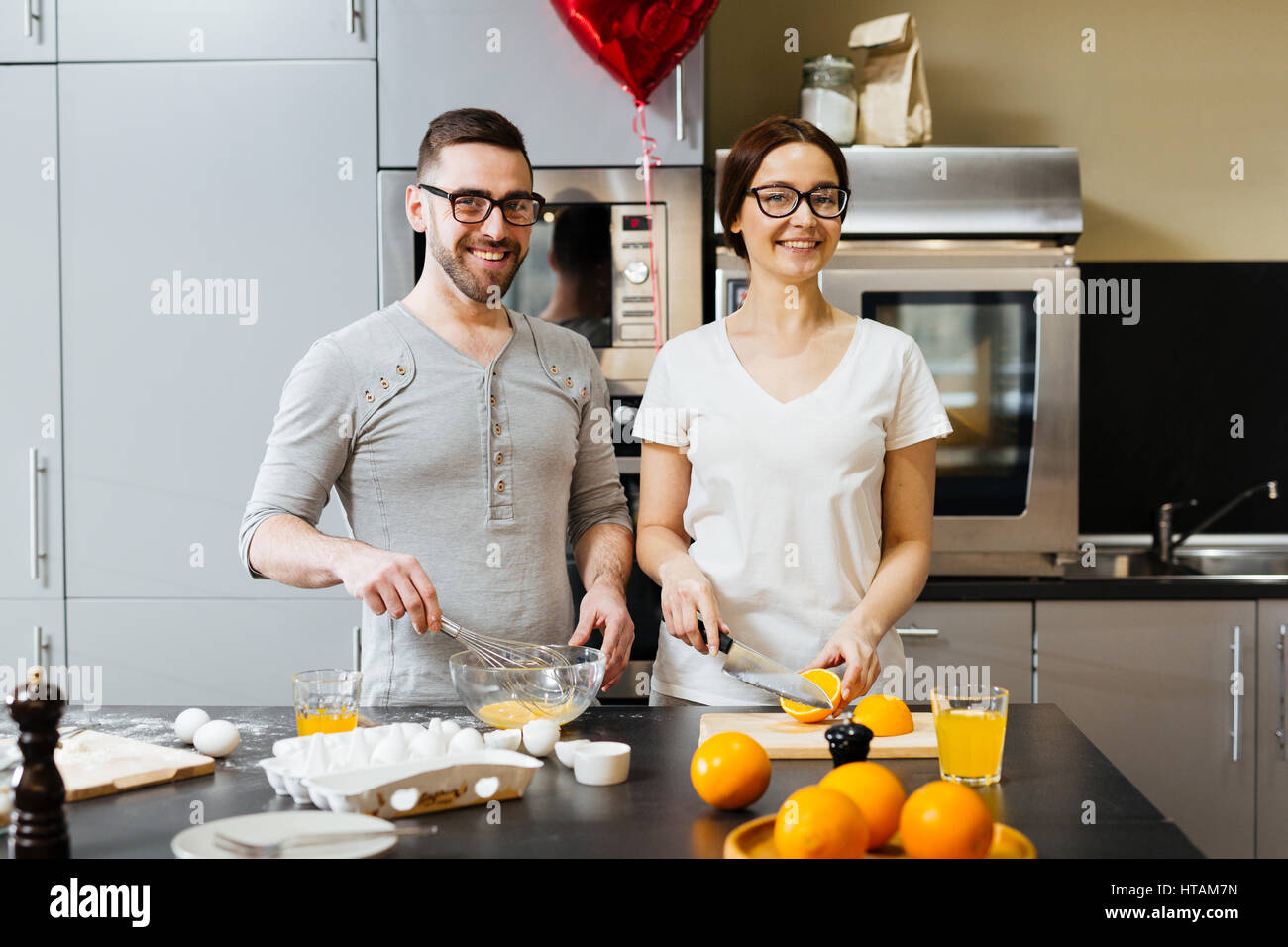 Amorous couple cooking together at home Stock Photo - Alamy