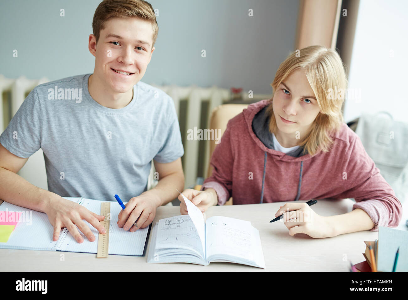 Two guys drawing design pictures in copybooks Stock Photo - Alamy