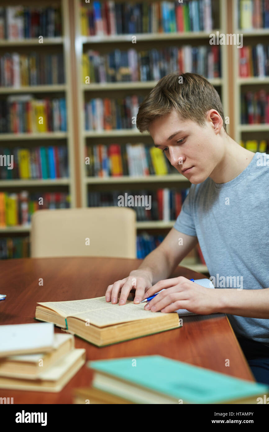 Serious learner rewriting text for seminar Stock Photo - Alamy