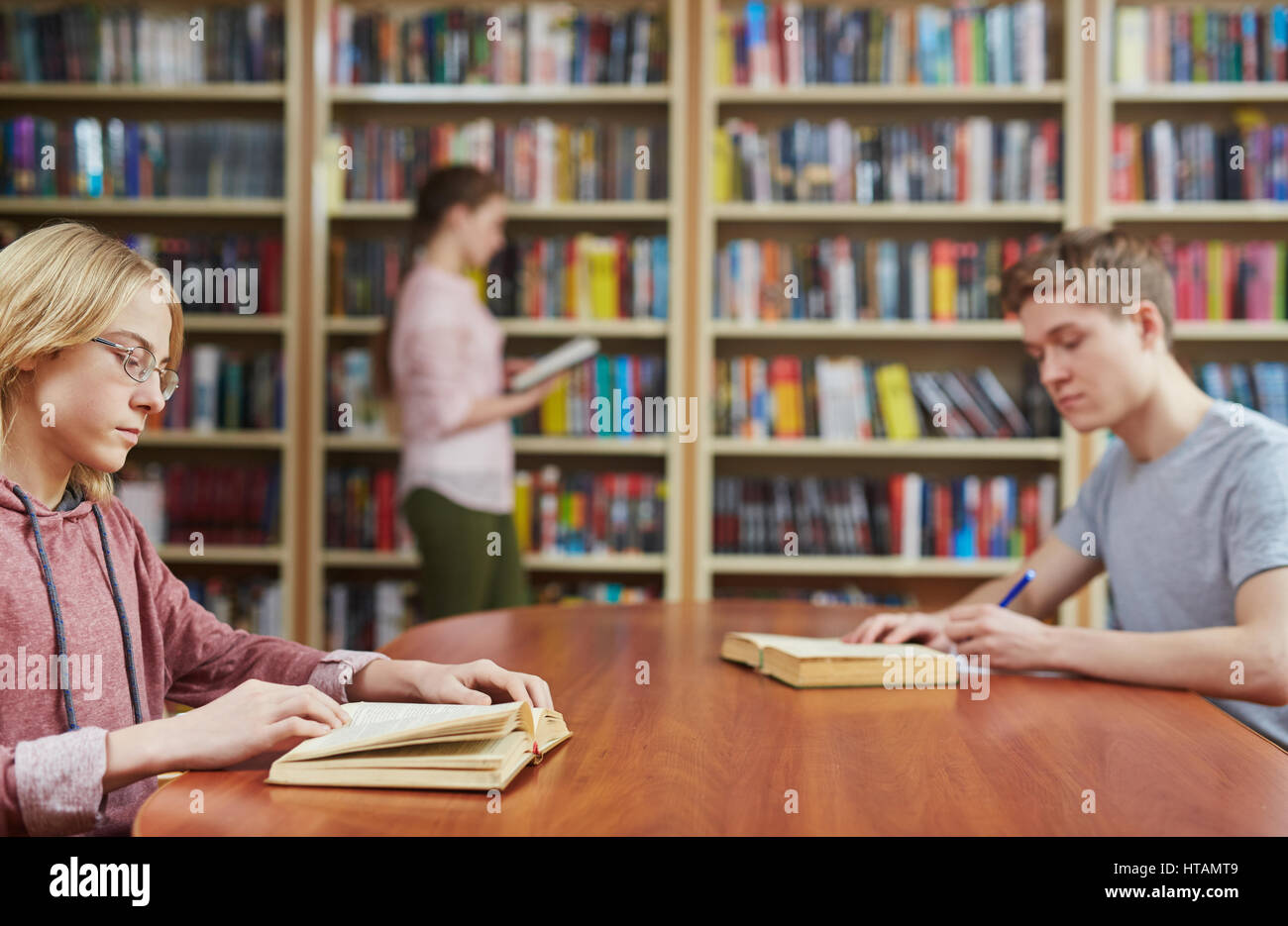 Clever students reading books in college library Stock Photo - Alamy