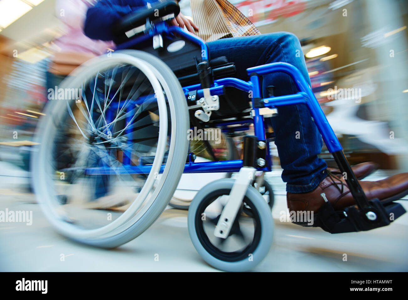 Invalid man in wheel-chair being pushed by caregiver Stock Photo - Alamy