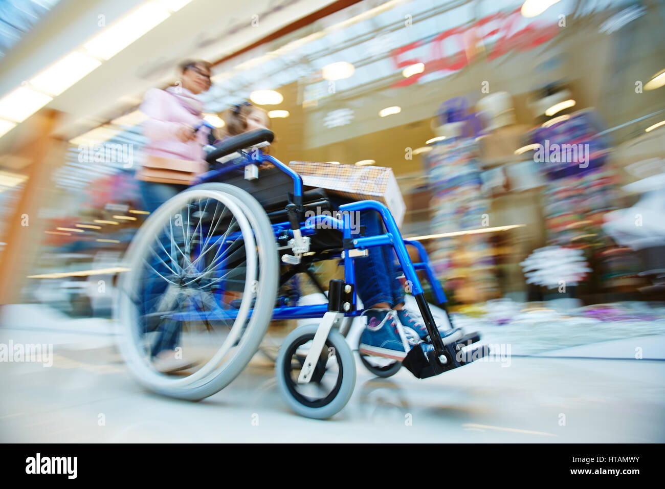 Child pushing wheelchair hi-res stock photography and images - Alamy