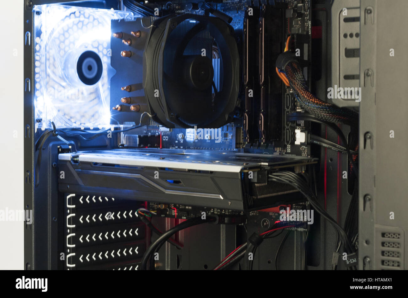 Close up view inside open midi tower computer case with red and blue ...