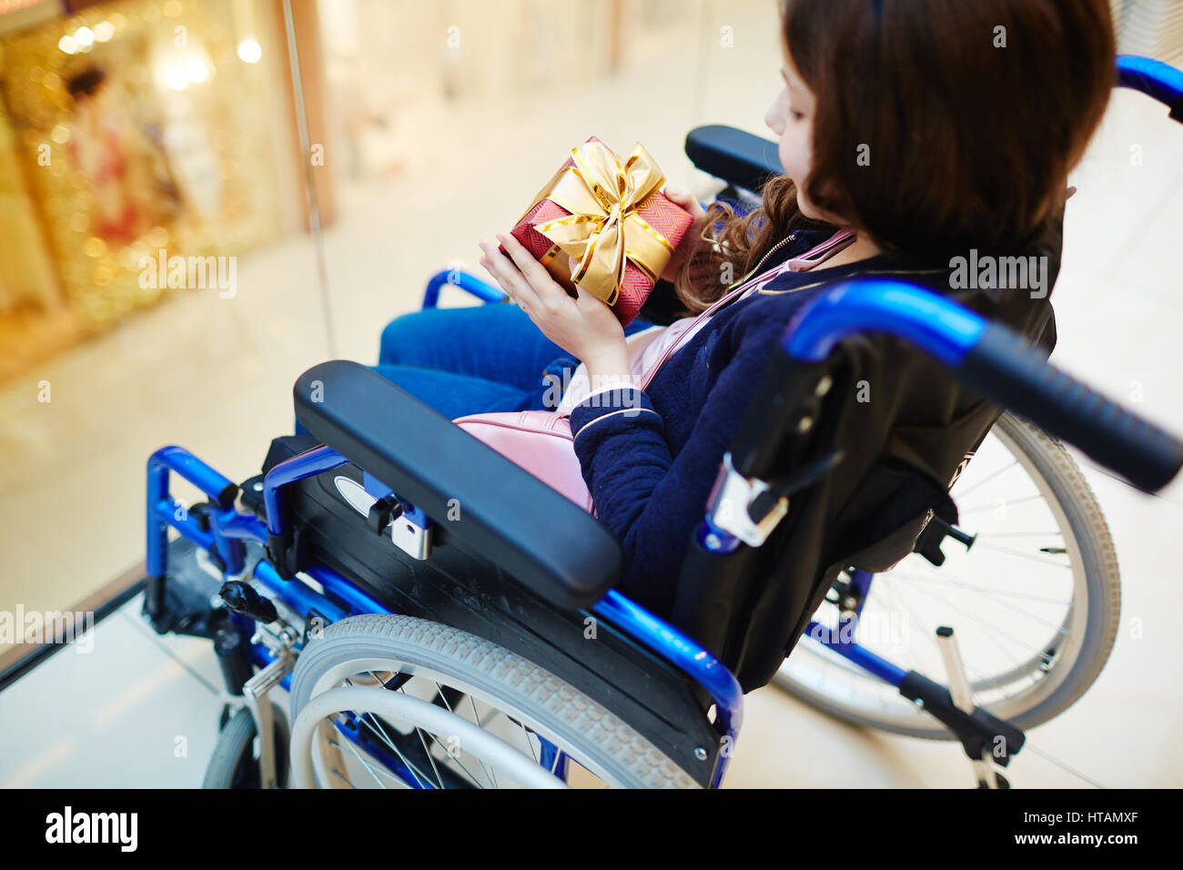 Gift-box in hands of disabled child Stock Photo - Alamy