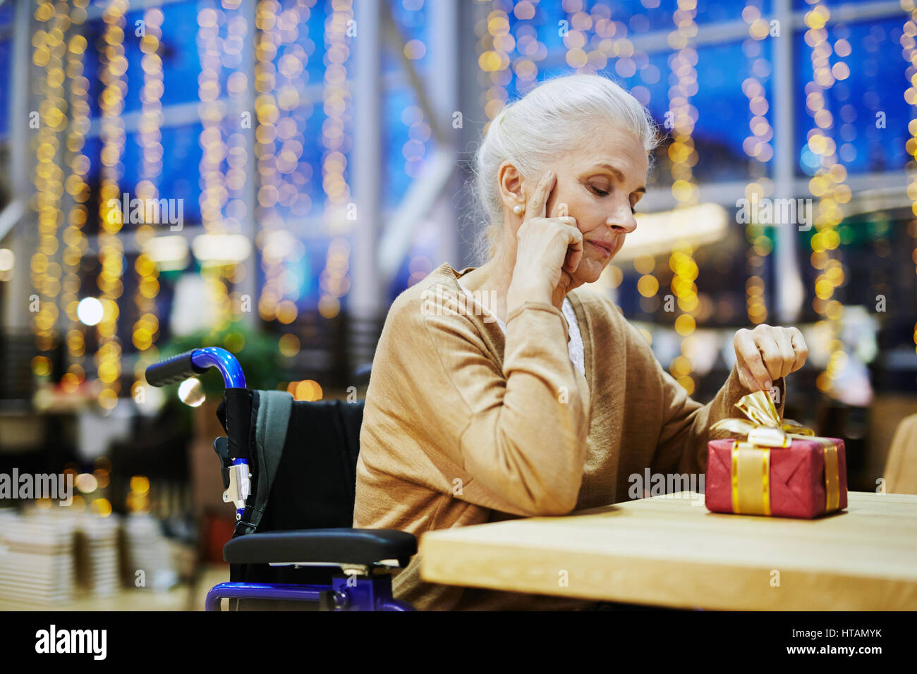 Disabled woman waiting for someone to give small present Stock Photo ...