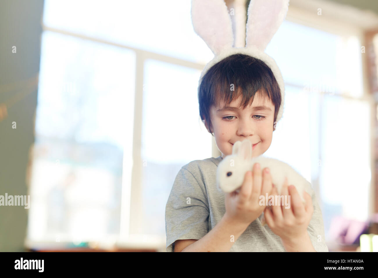 Little boy holding cute fluffy friend Stock Photo - Alamy